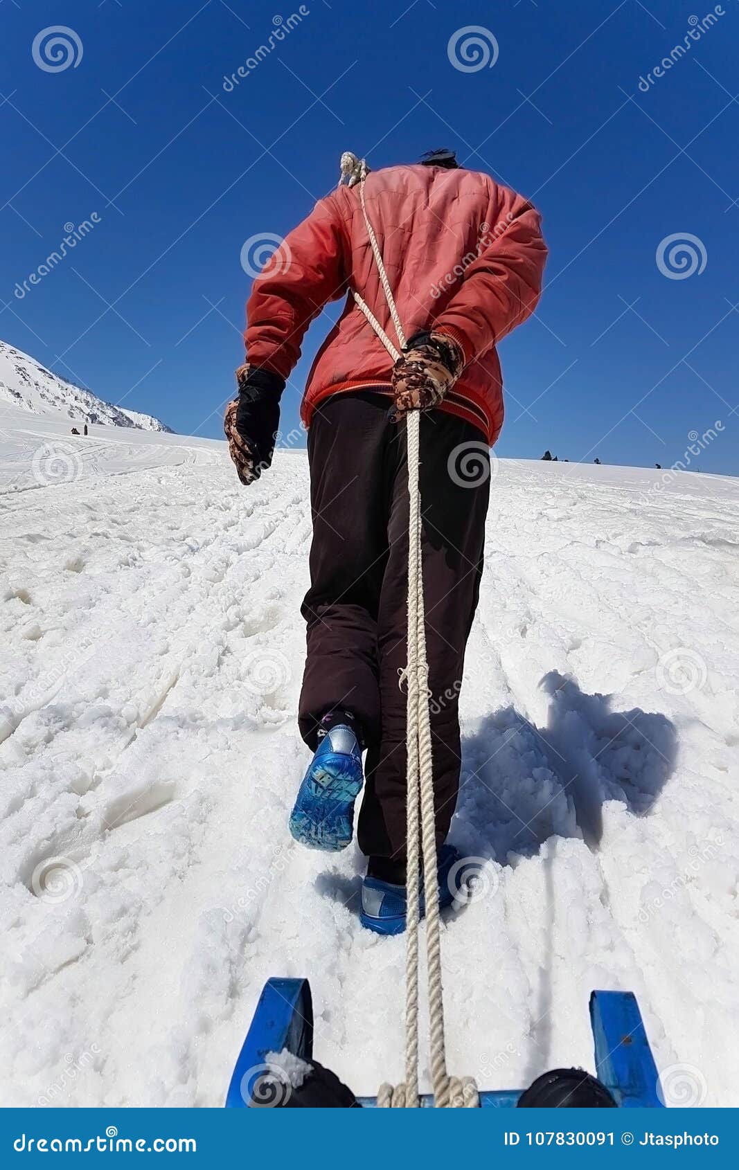 Man pull snow sled stock image. Image of sideways, rear - 107830091