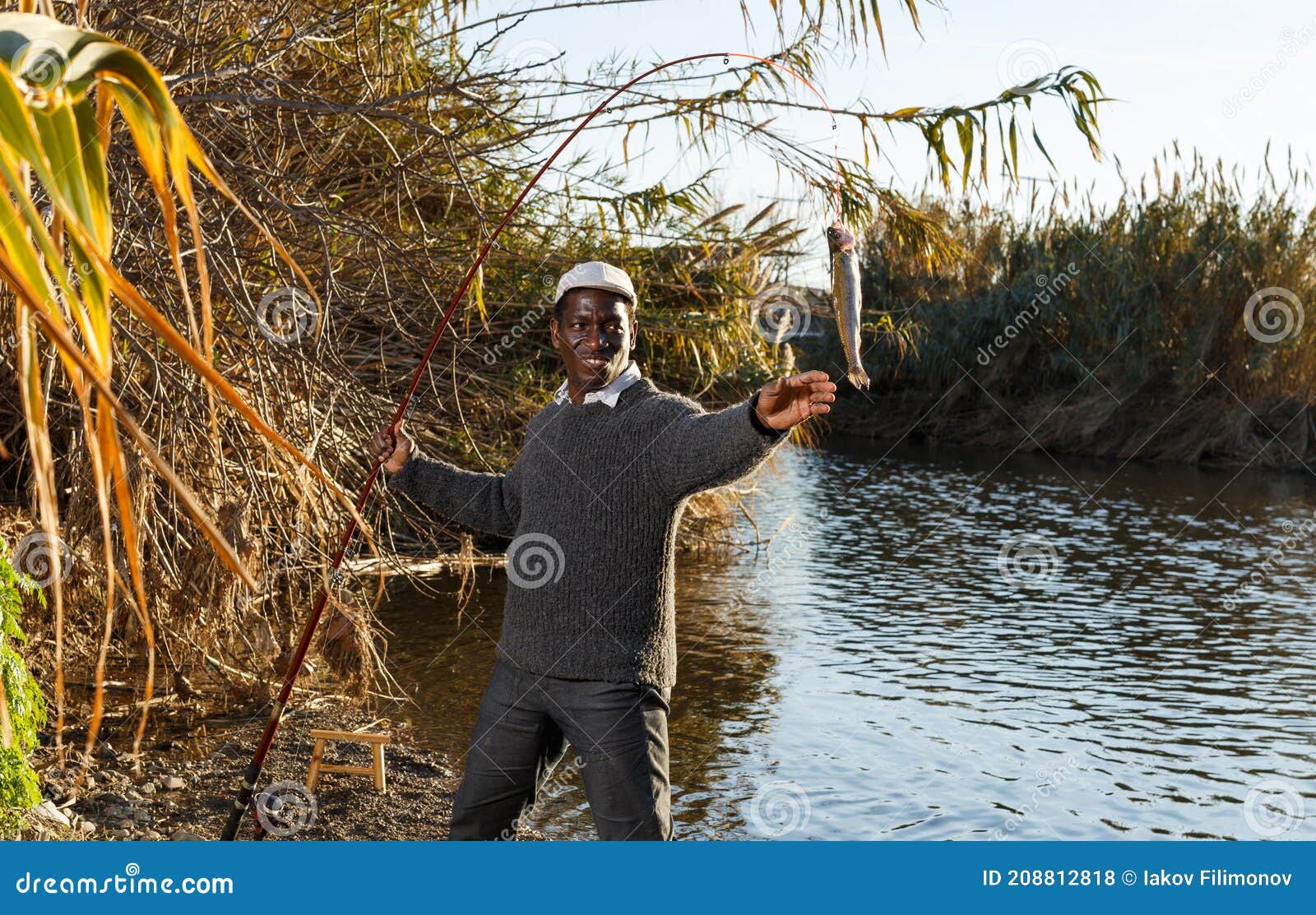 Man pulling fish on hook stock photo. Image of bucket - 208812818
