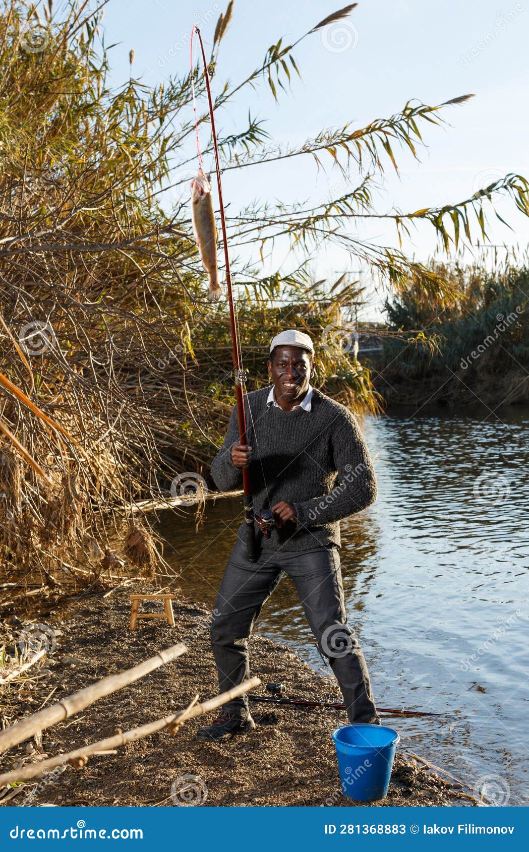 Man pulling fish on hook stock image. Image of afro - 281368883