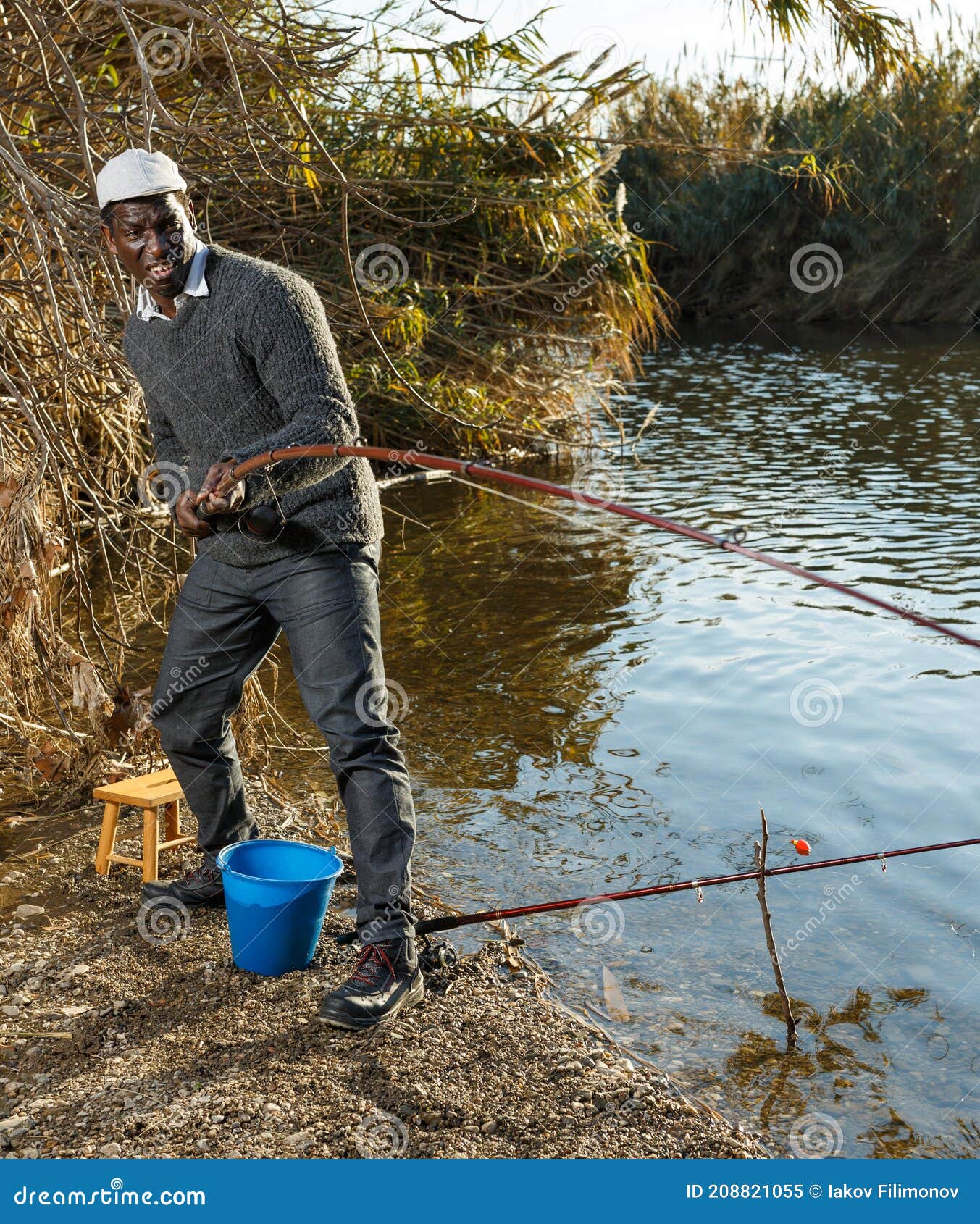 Man and Pulling Fish Near River Stock Image - Image of angler, holiday ...