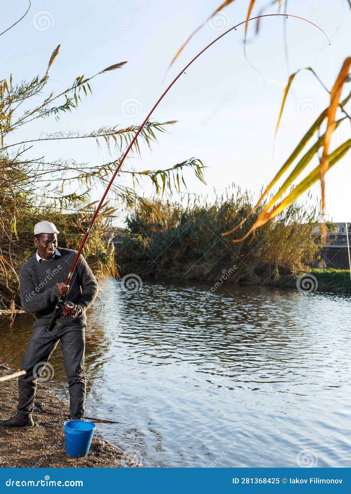 Man and Pulling Fish Near River Stock Image - Image of afro, park ...