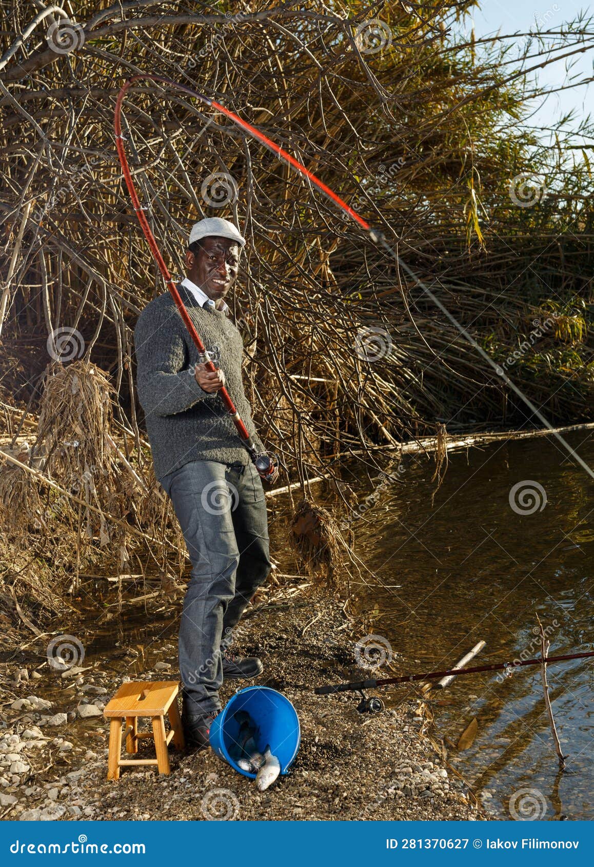 Man and Pulling Fish Near River Stock Image - Image of fish, natural ...