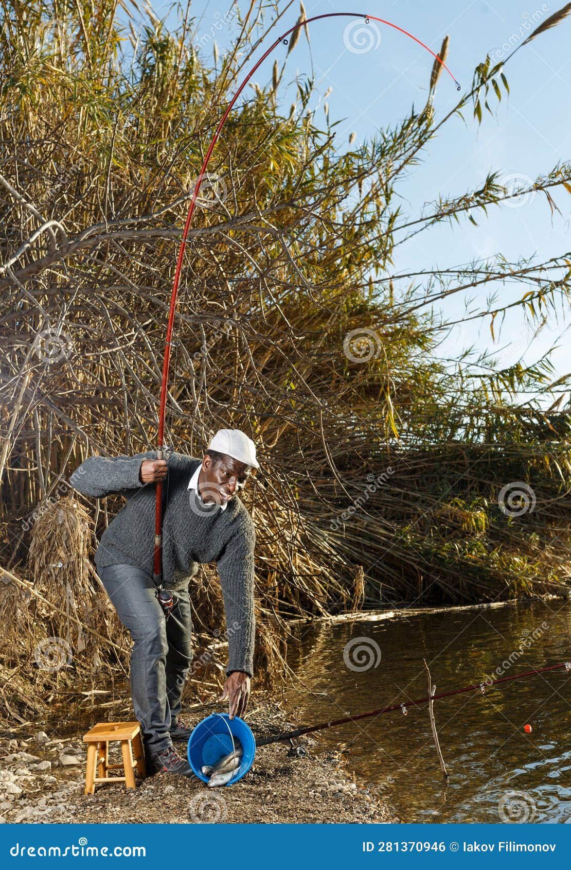 Man and Pulling Fish Near River Stock Photo - Image of wild, leisure ...