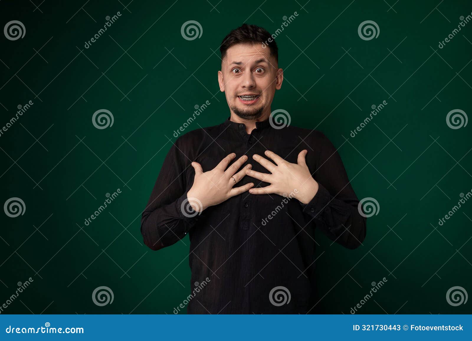 Man Pulling Funny Face in Front of Green Background Stock Image - Image ...