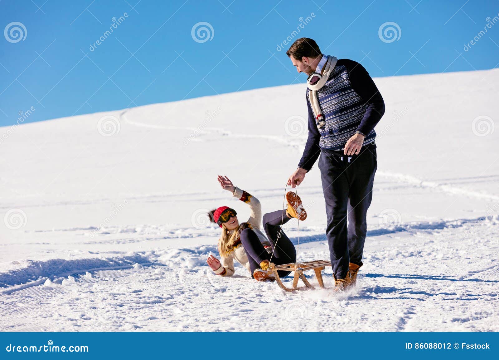 Man Pulling Girl on a Sled at Snow - Concept: Winter Fun Stock Photo ...