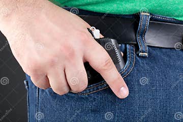 Man Pulling Gun Out of Pocket Stock Photo - Image of weapon, horizontal ...