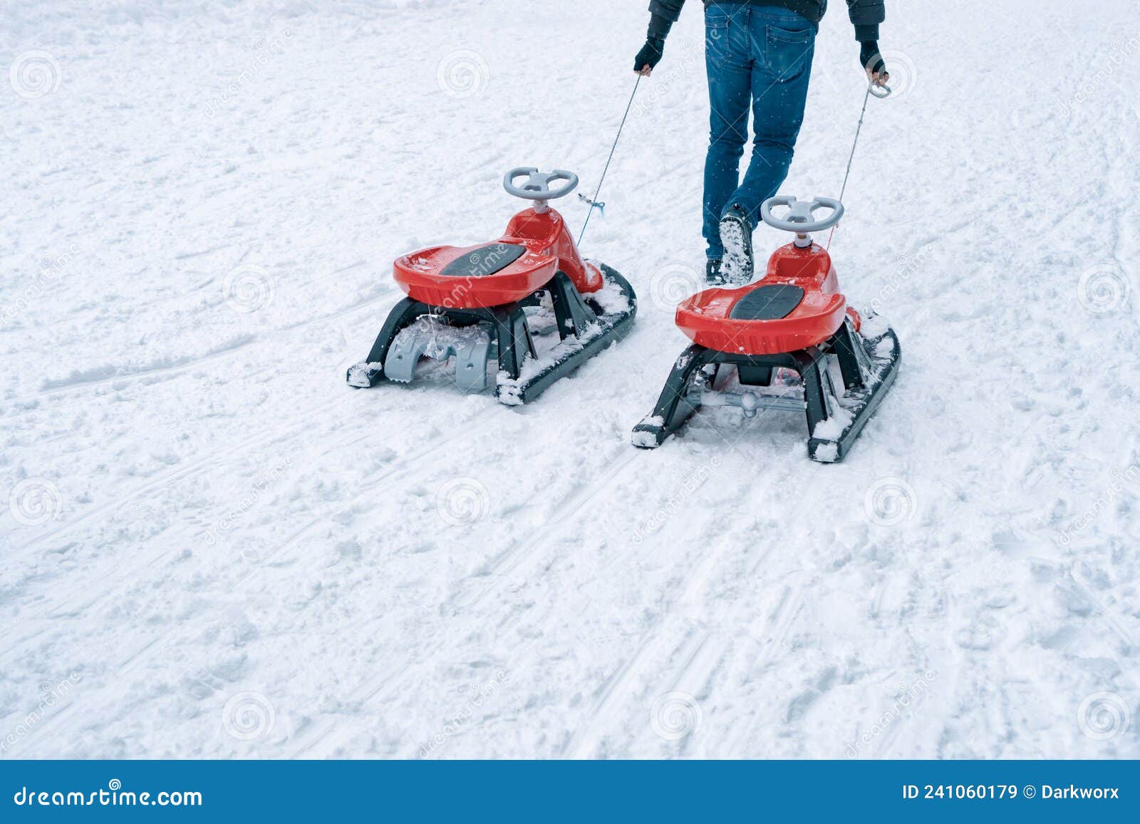 Man Pulling Two Ski Sled with Steering Wheel on Snow in Winter Stock ...