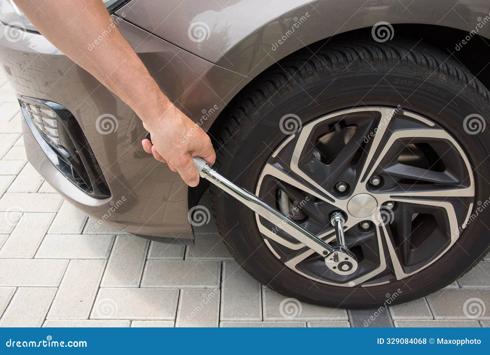 Man Pulling in Tire with a Torque Moment Wrench Stock Photo - Image of ...