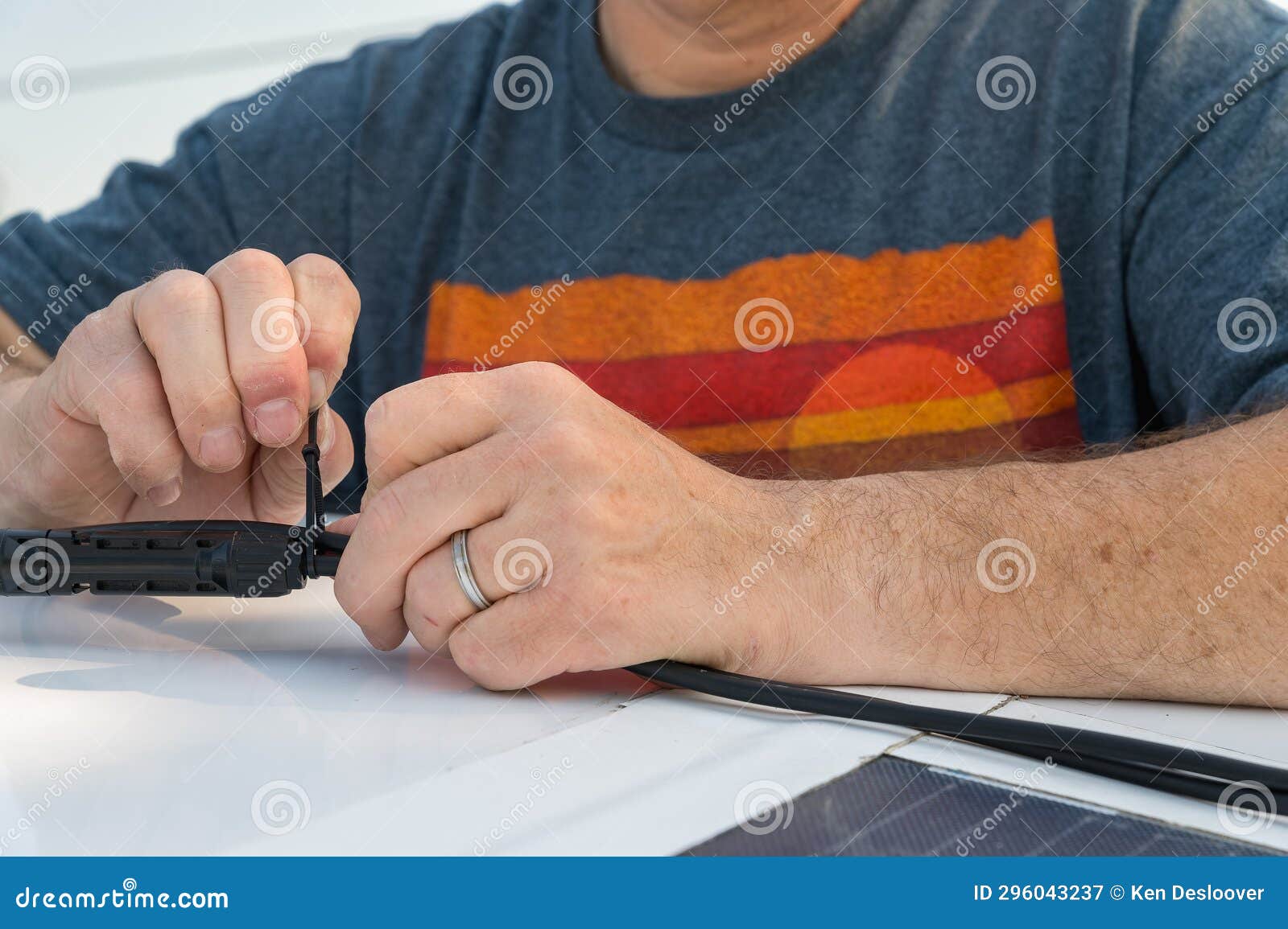 Man Pulling a Zip Tie Tight To Secure a Solar Panel Connection Stock ...