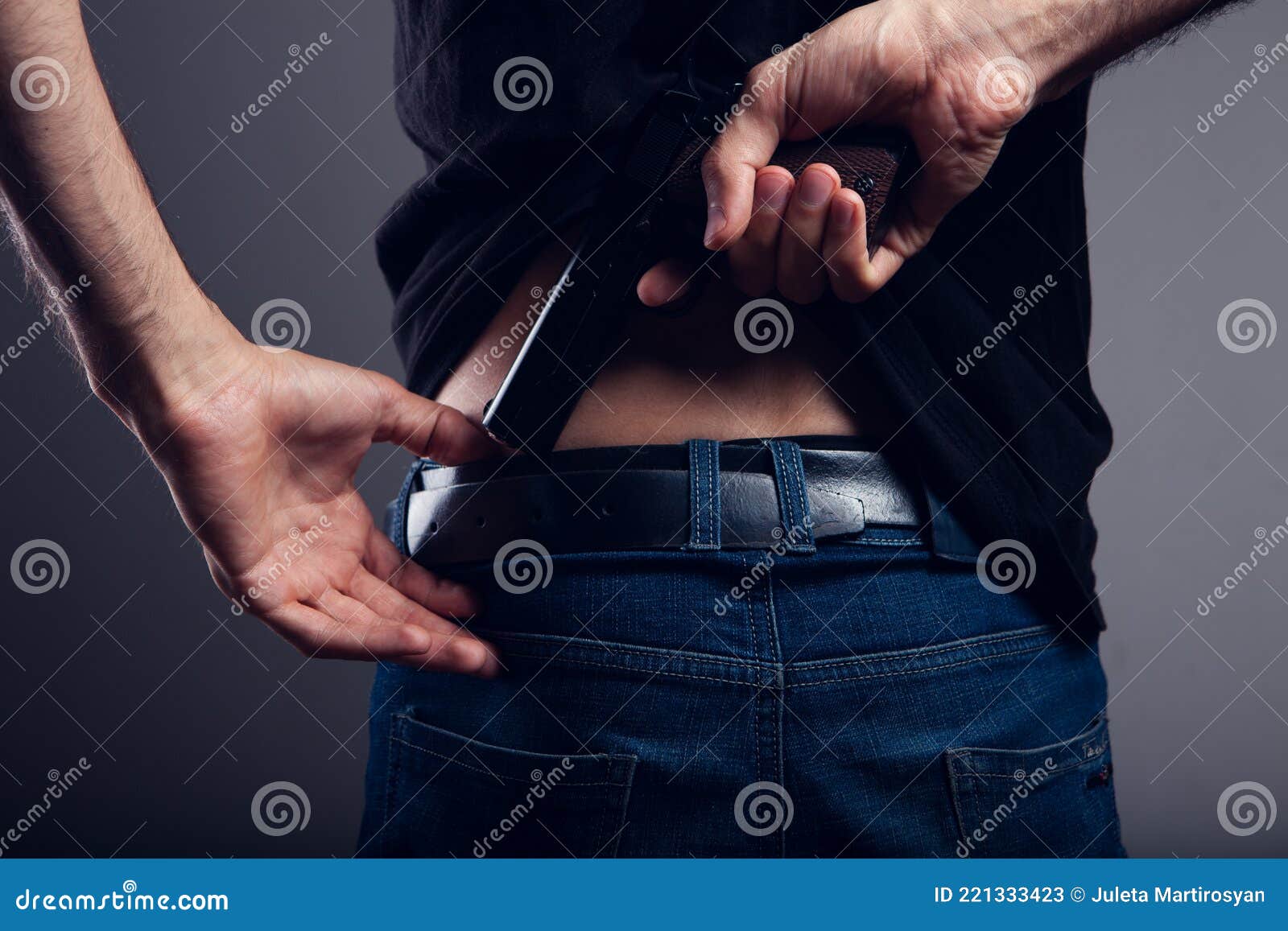 A Man Pulls a Gun from Behind Stock Image - Image of pistol, jeans ...