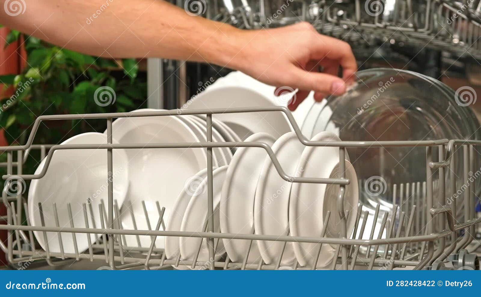 Man Pulls Out Dishwasher Basket and Unloads Clean Plates. Release of ...