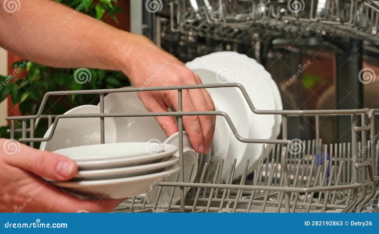 Man Pulls Out Dishwasher Basket and Unloads Clean Plates. Release of ...