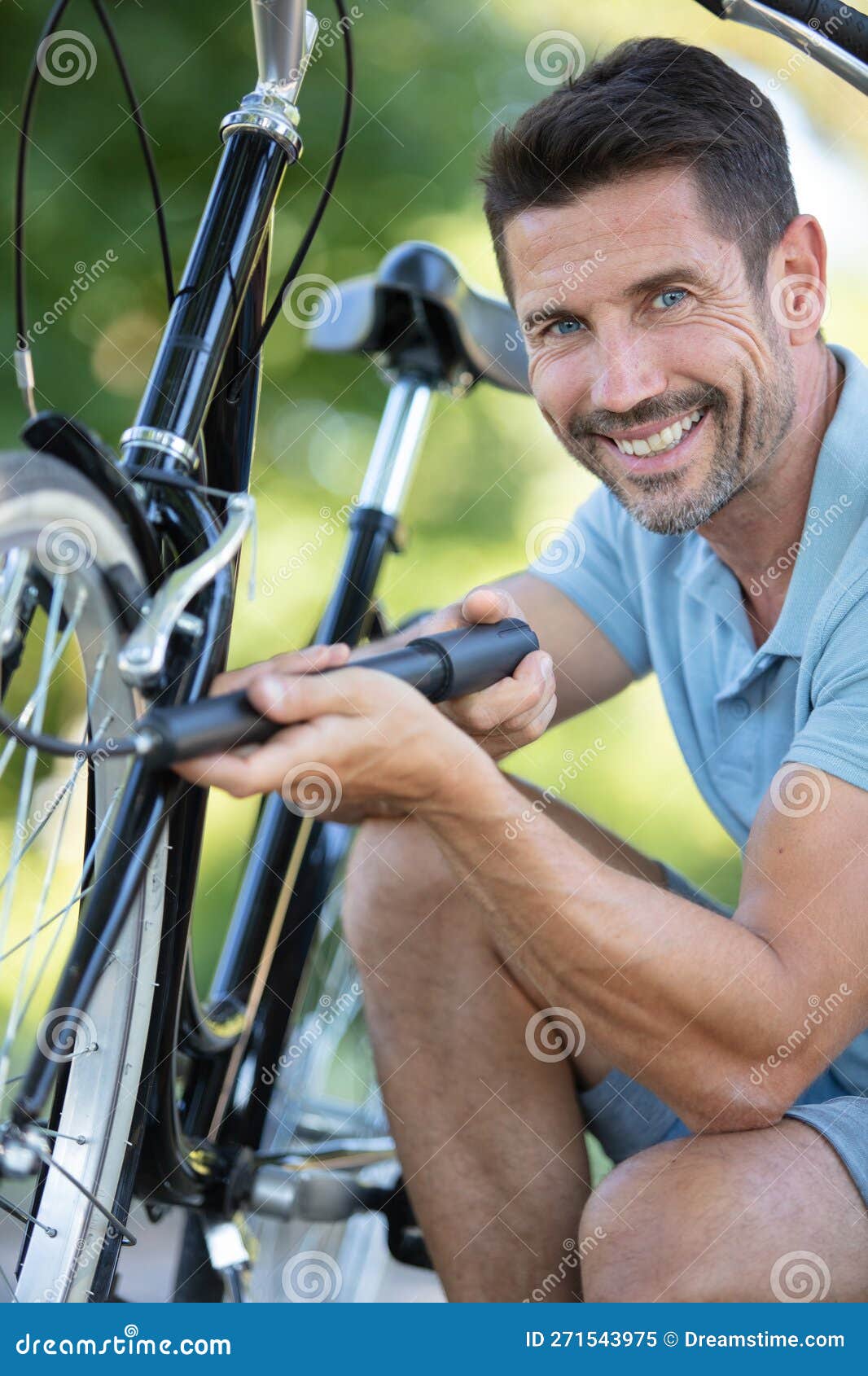 Man pumping bicycle wheel stock image. Image of repairman - 271543975