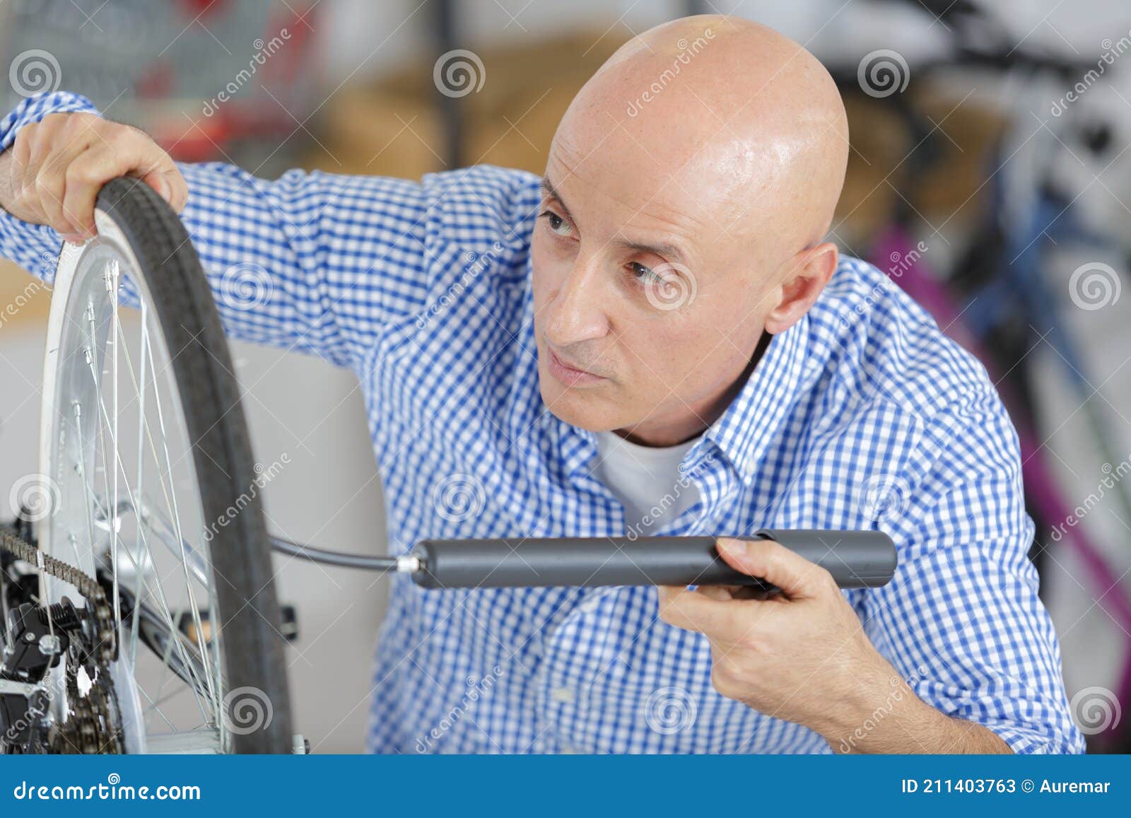 Man Pumping Up Tires on Bicycle Stock Image - Image of folding, indoors ...