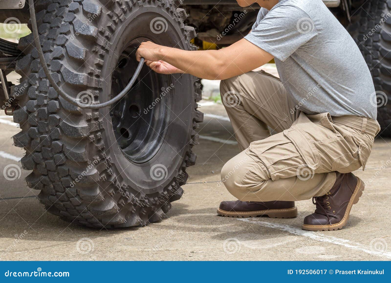 Man Pumps A Wheel At The Car, Observes A Norm Of Pressure In Tires ...