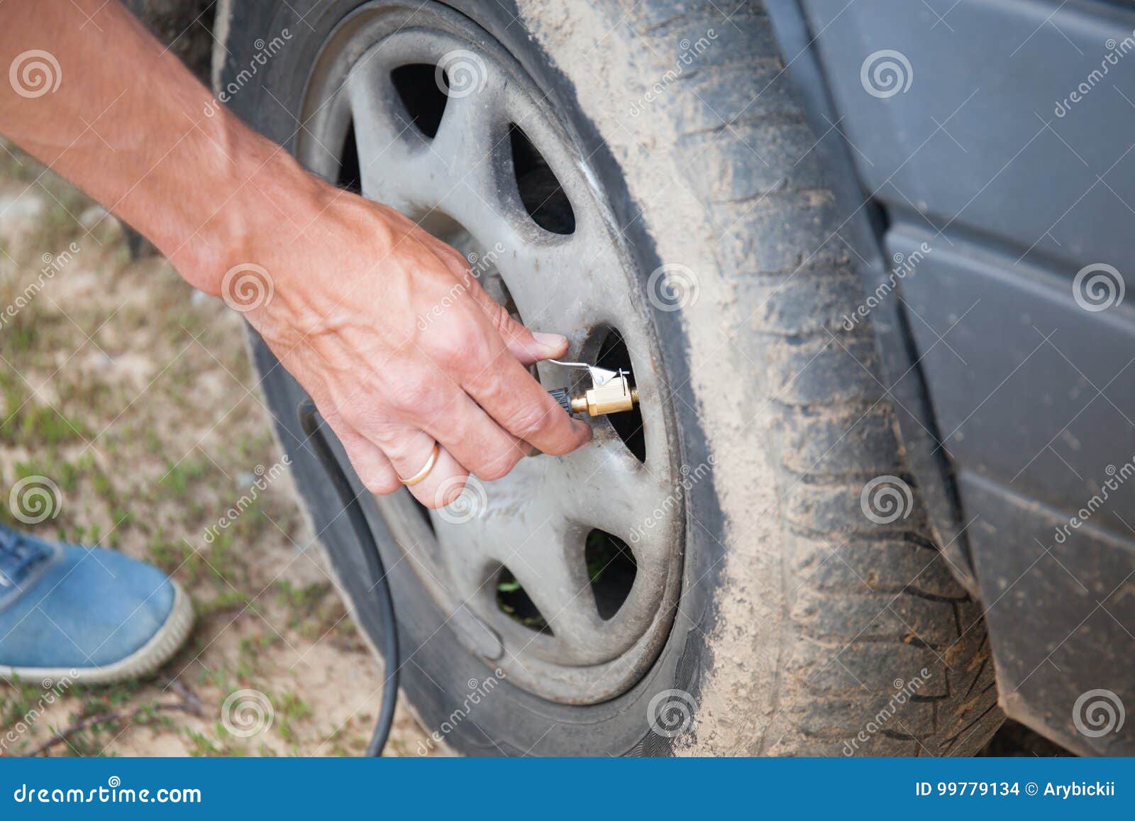 Man Pumps A Wheel At The Car, Observes A Norm Of Pressure In Tires ...