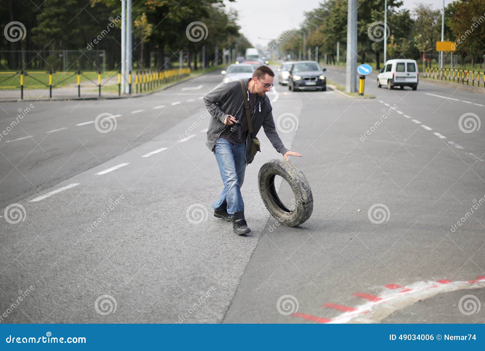 Man Pushes the Car Tire on Street Stock Photo - Image of motion, fell ...
