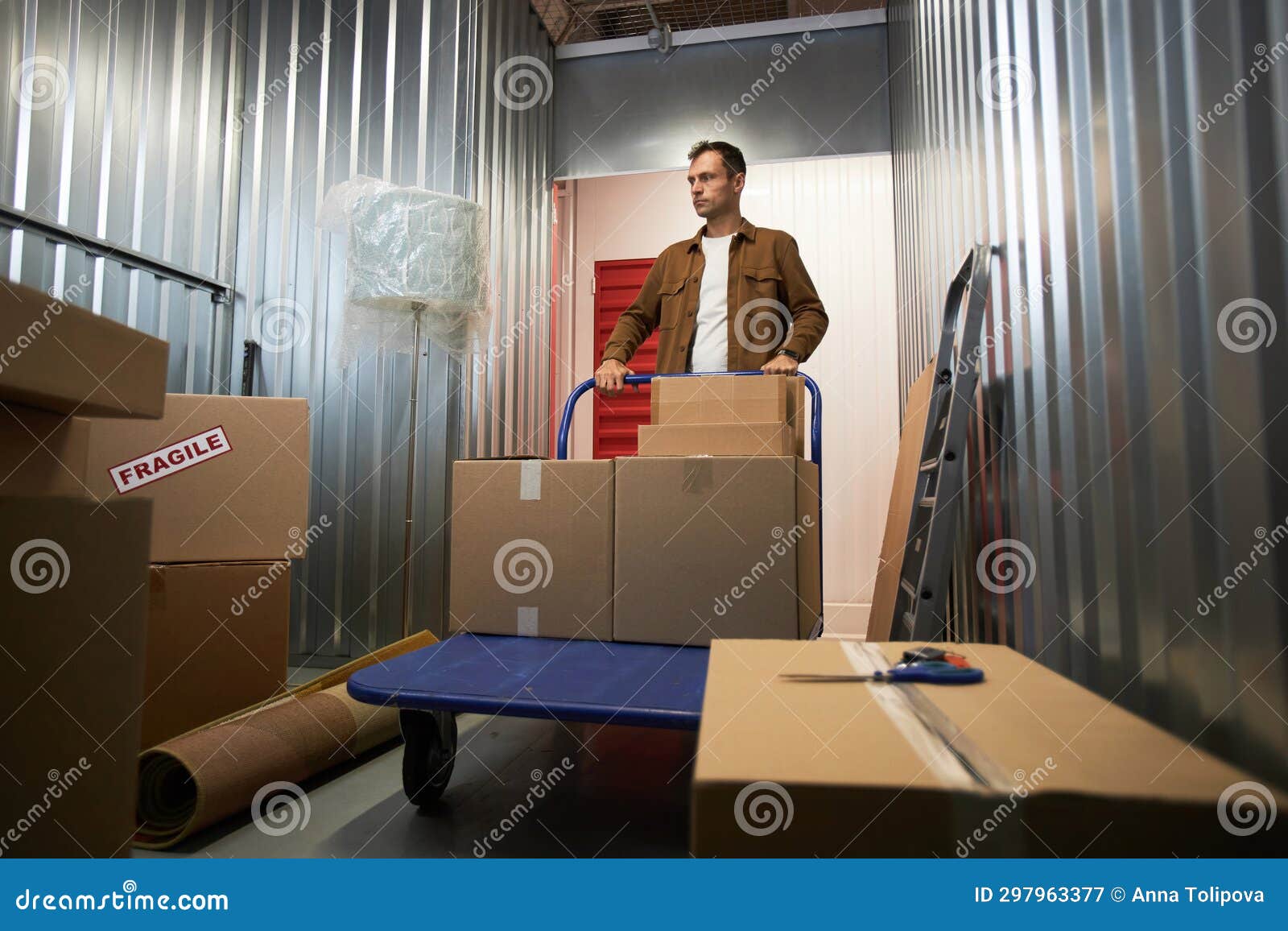 Man Pushing Cart Inside Storage Unit Stock Image - Image of locker ...