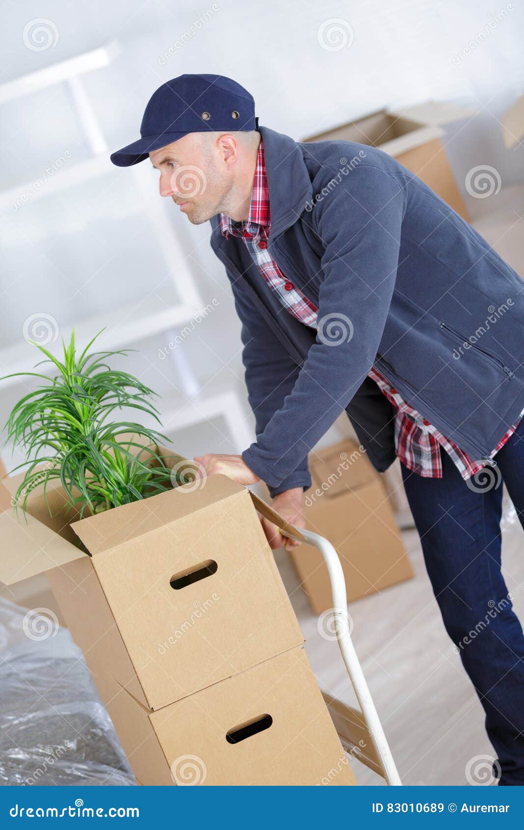 Man Pushing Stack Moving Boxes on Hand Truck Stock Image - Image of ...