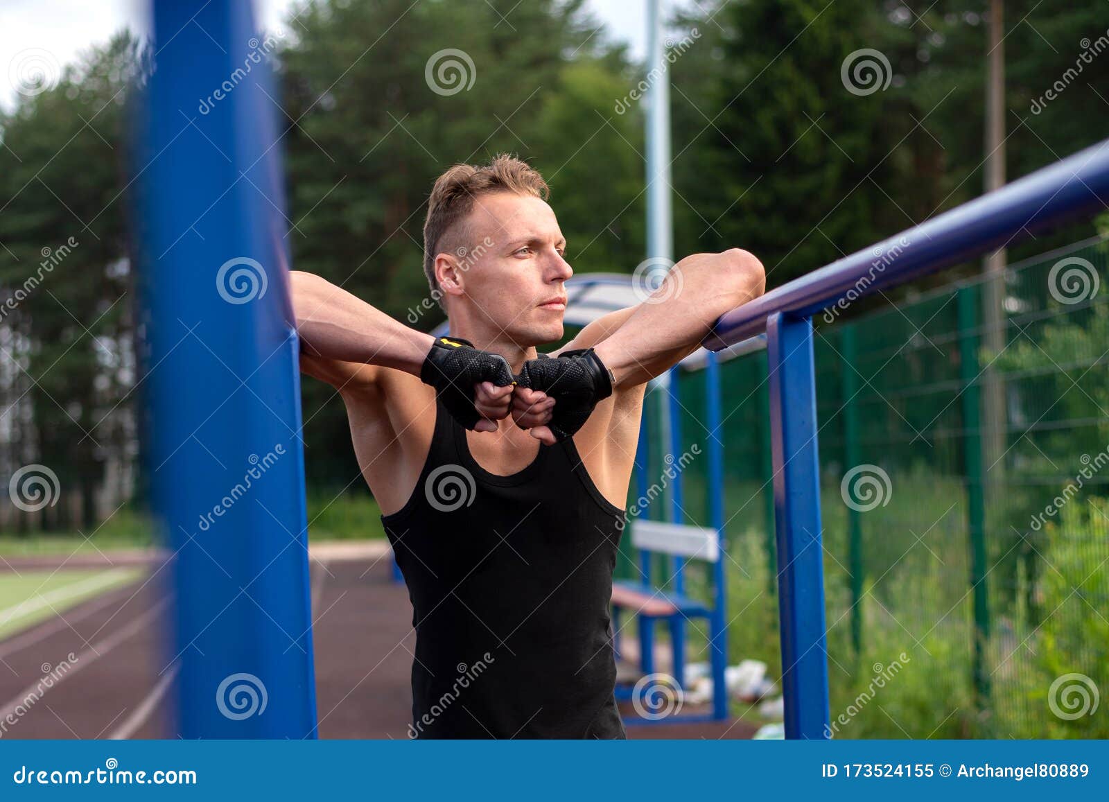 A Man is Pushing Up from Parallel Bars Stock Image - Image of cross ...