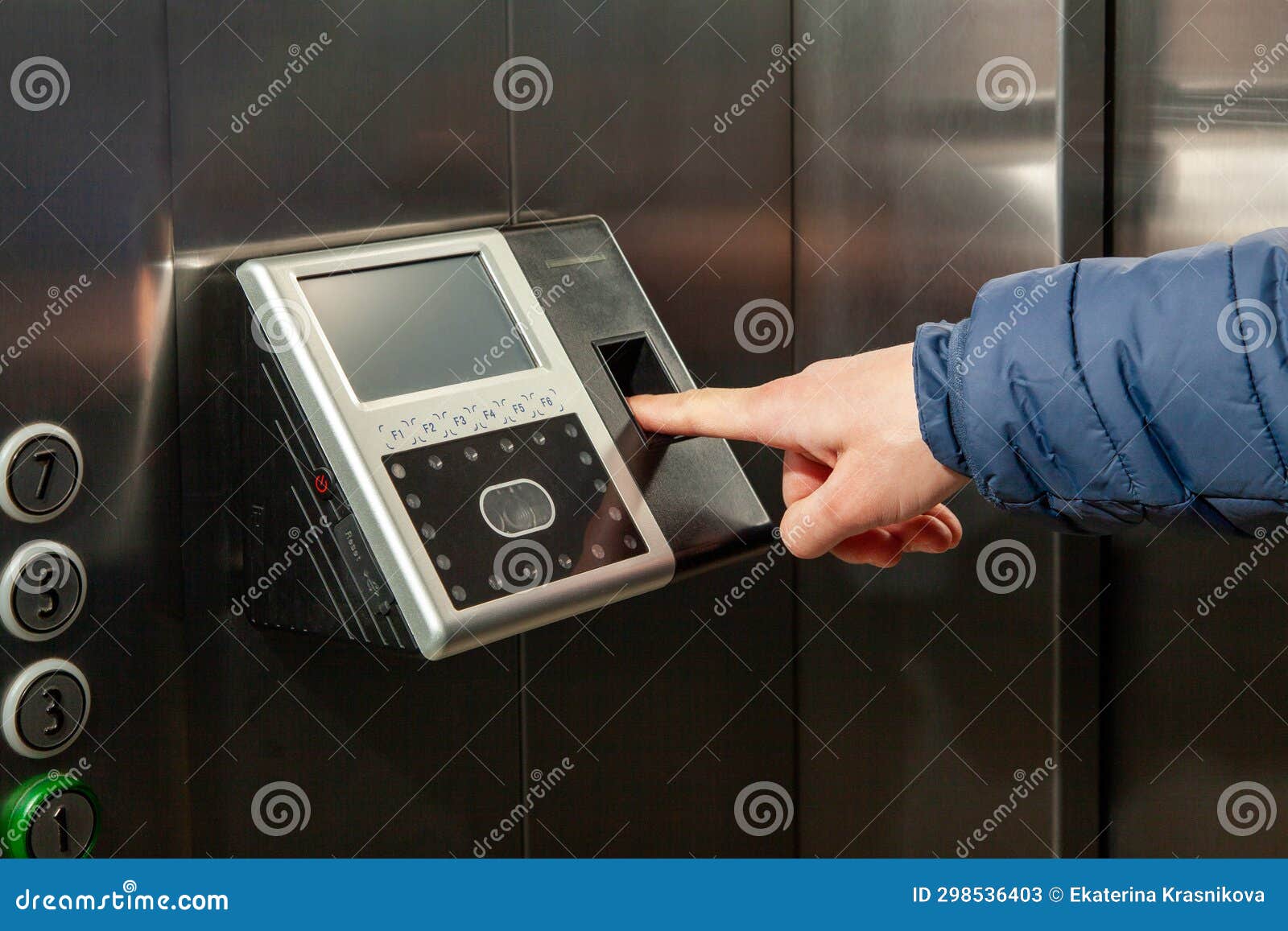The Man Put His Finger in the Fingerprint Access Control Terminal with Face Recognition Function ...
