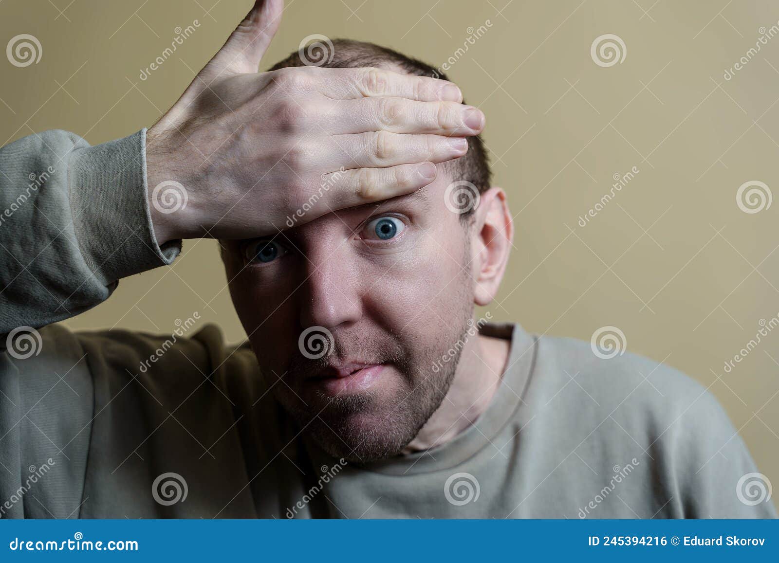 The Man Put His Hand To His Forehead. Portrait of a Young Man Making ...