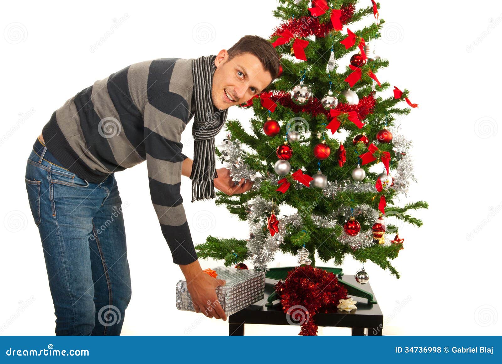Man put present under tree stock photo. Image of smiling - 34736998