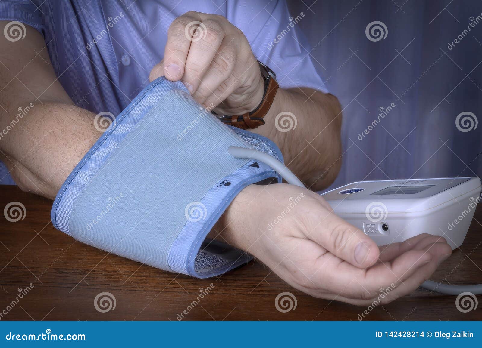 A Man Puts on a Device for Measuring Blood Pressure Stock Photo - Image ...