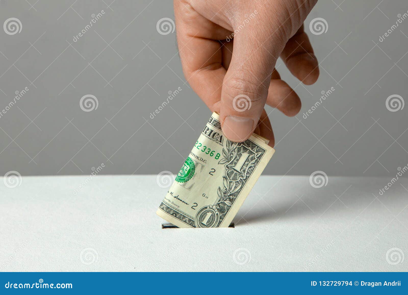 Man Puts His Hand on Dollar Bill in the Slot of a Donation Box. Stock ...