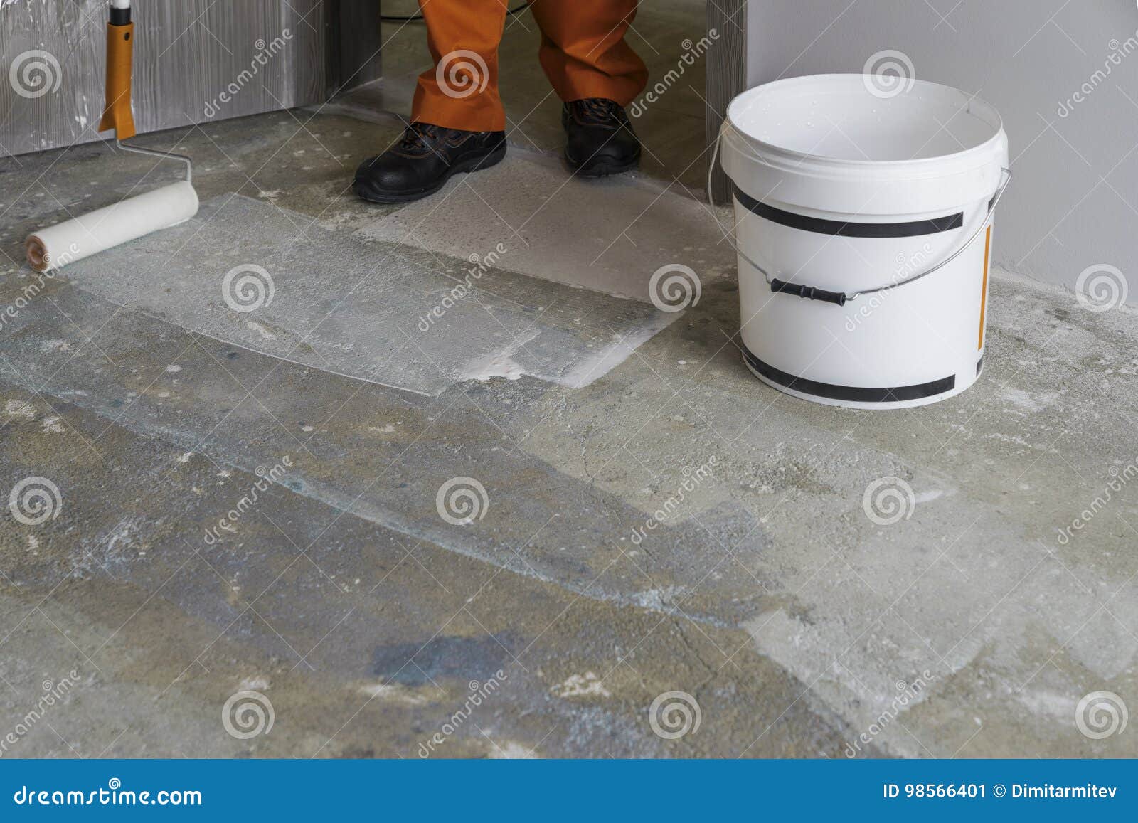 Man Puts Primer with Roller on Concrete Floor. House Under Const Stock ...
