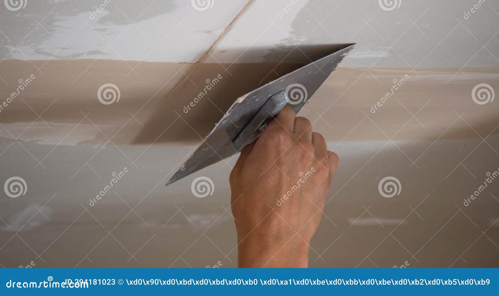 A Man Puts Putty on a Plasterboard Ceiling. Putty for the Joints of ...