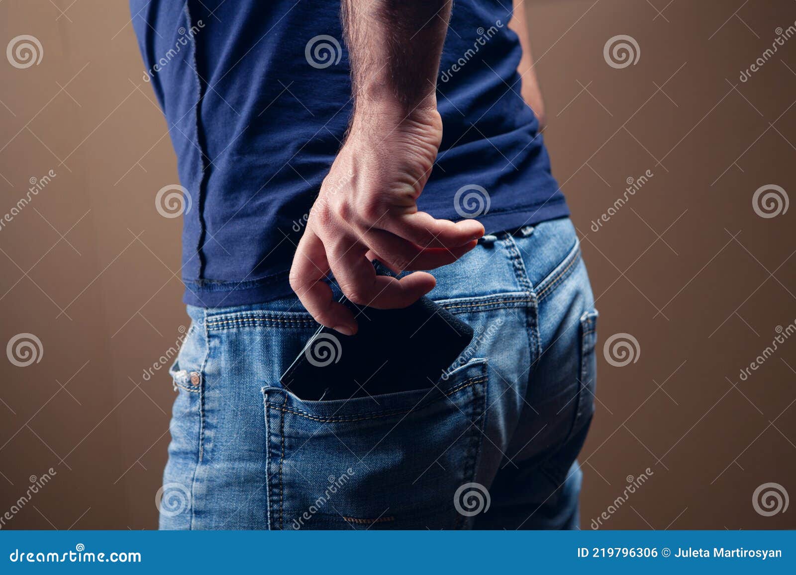 Man Puts Wallet in Back Pocket Stock Photo - Image of puts, pocket ...