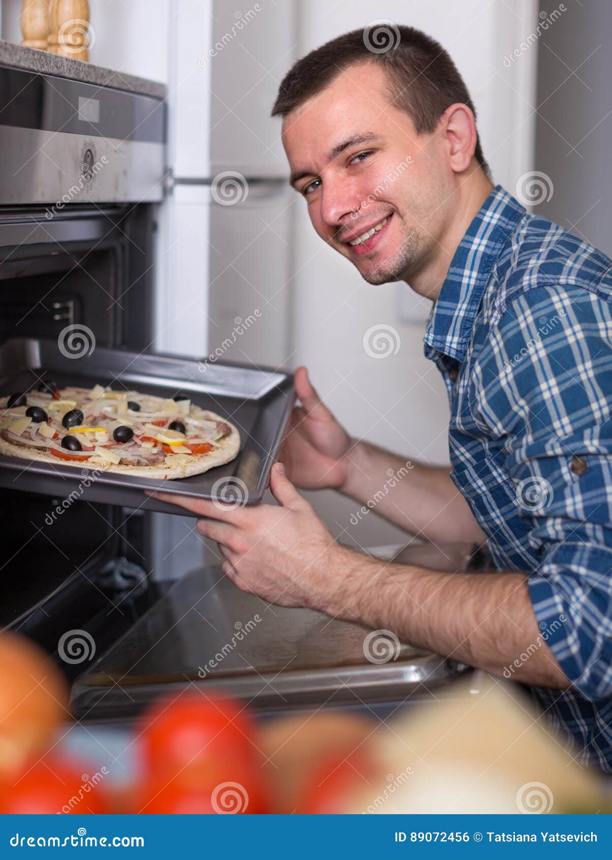 Man Putting a Baking Sheet into the Oven with Pizza Stock Photo - Image ...