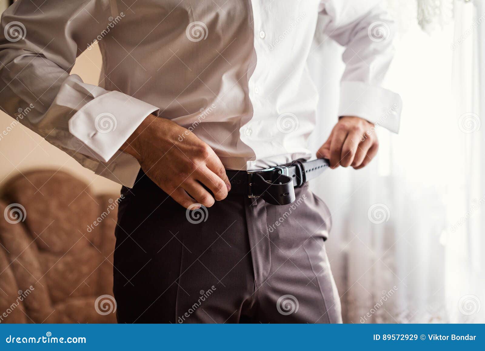 Man putting on a belt stock image. Image of adult, hand - 89572929