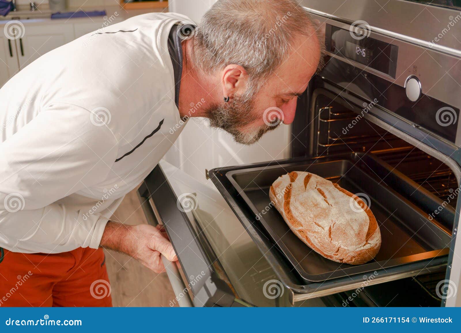 Man Putting Bread in the Oven Stock Photo - Image of flavor, standing ...