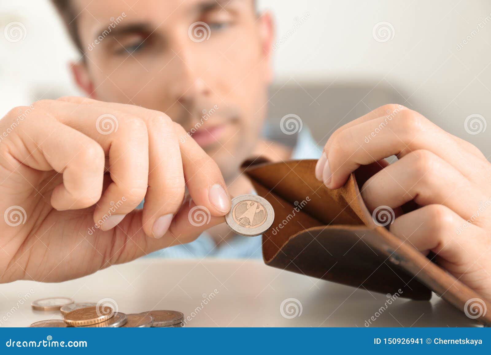 Man Putting Coins into Wallet at Table Stock Image - Image of currency ...