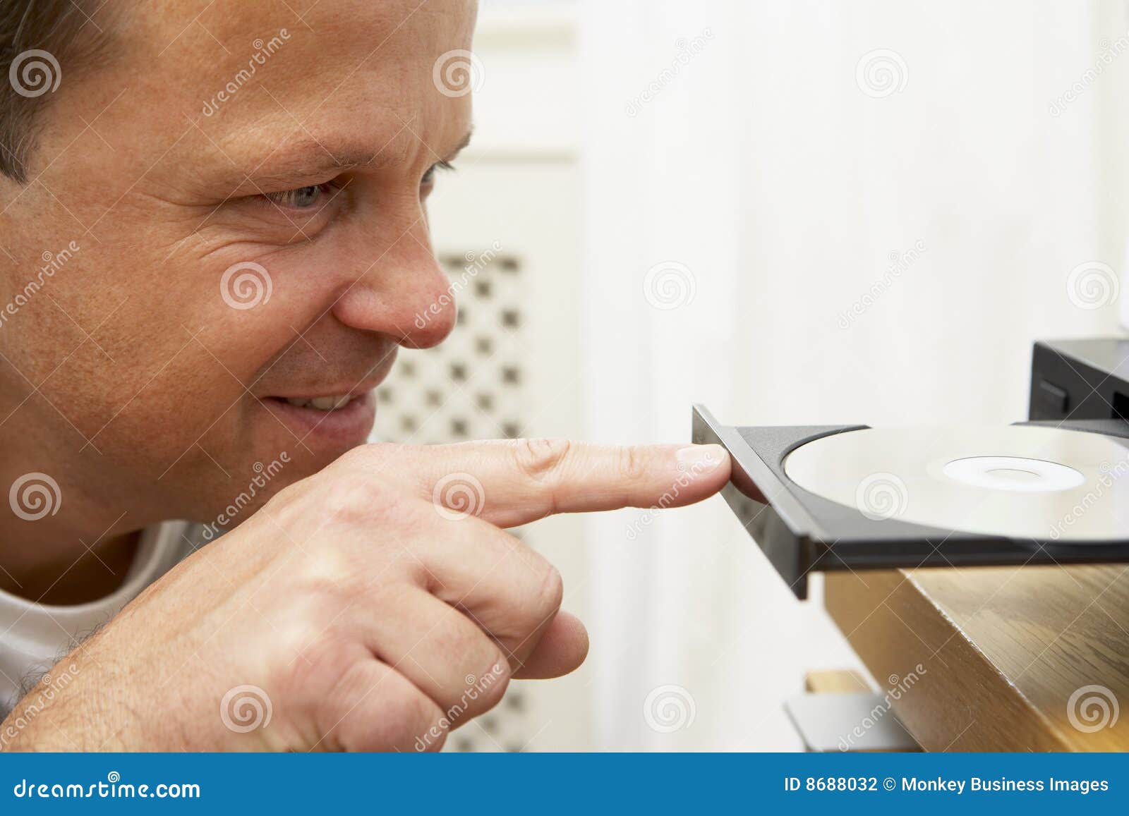 Man Putting Disc in DVD stock photo. Image of person, room - 8688032