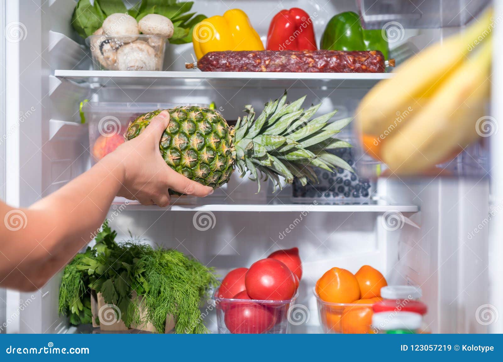 Man Putting Fresh Pineapple into Fridge Stock Image - Image of fridge ...