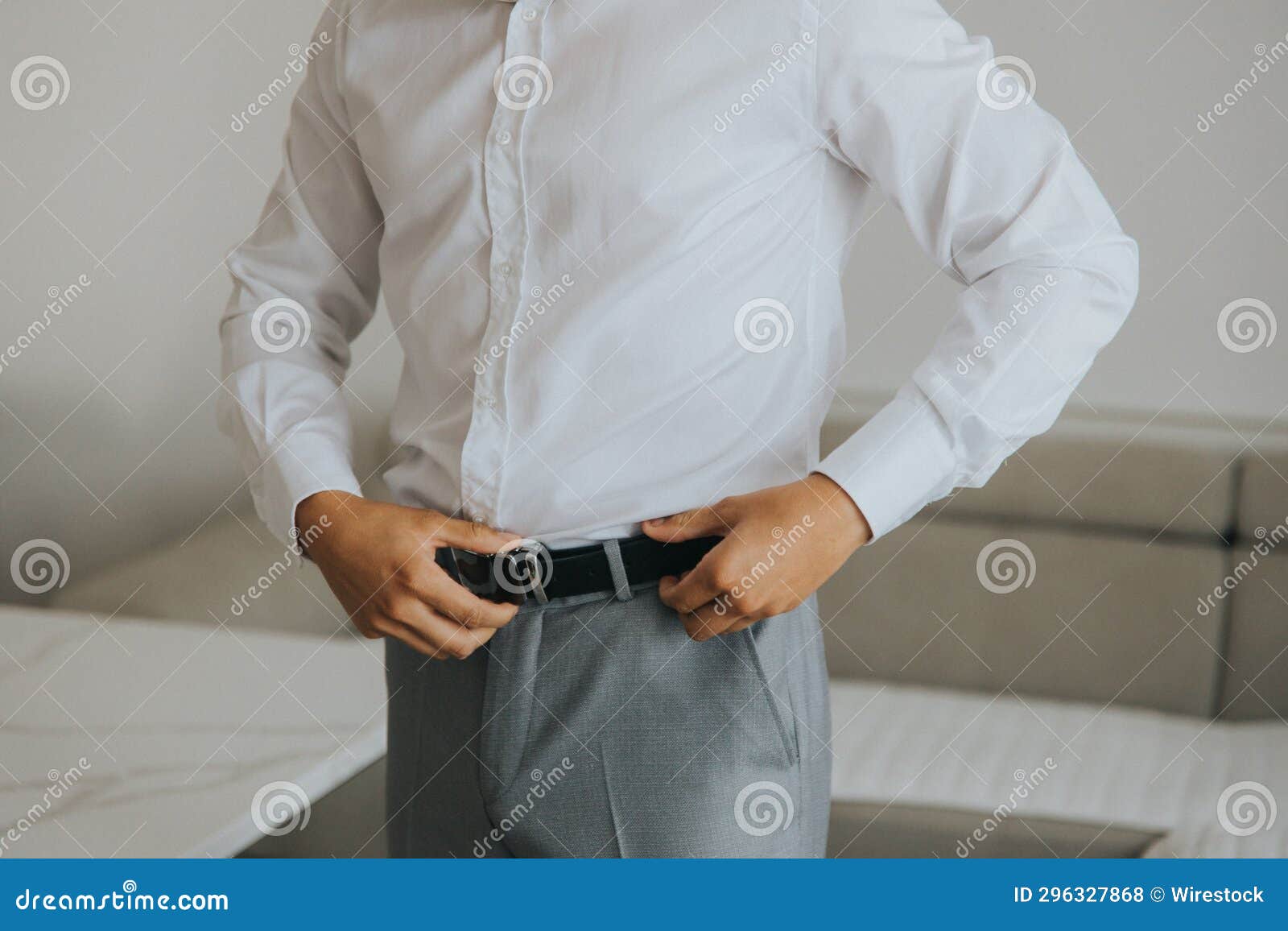 A Man Putting His Shirt on and Looking Down in the Camera Stock Photo ...