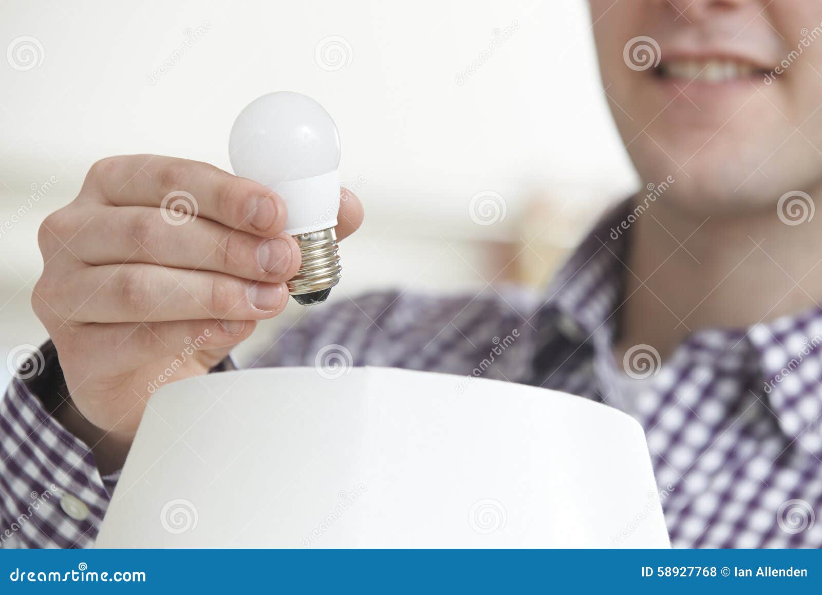 Man Putting Low Energy LED Lightbulb into Lamp at Home Stock Photo ...