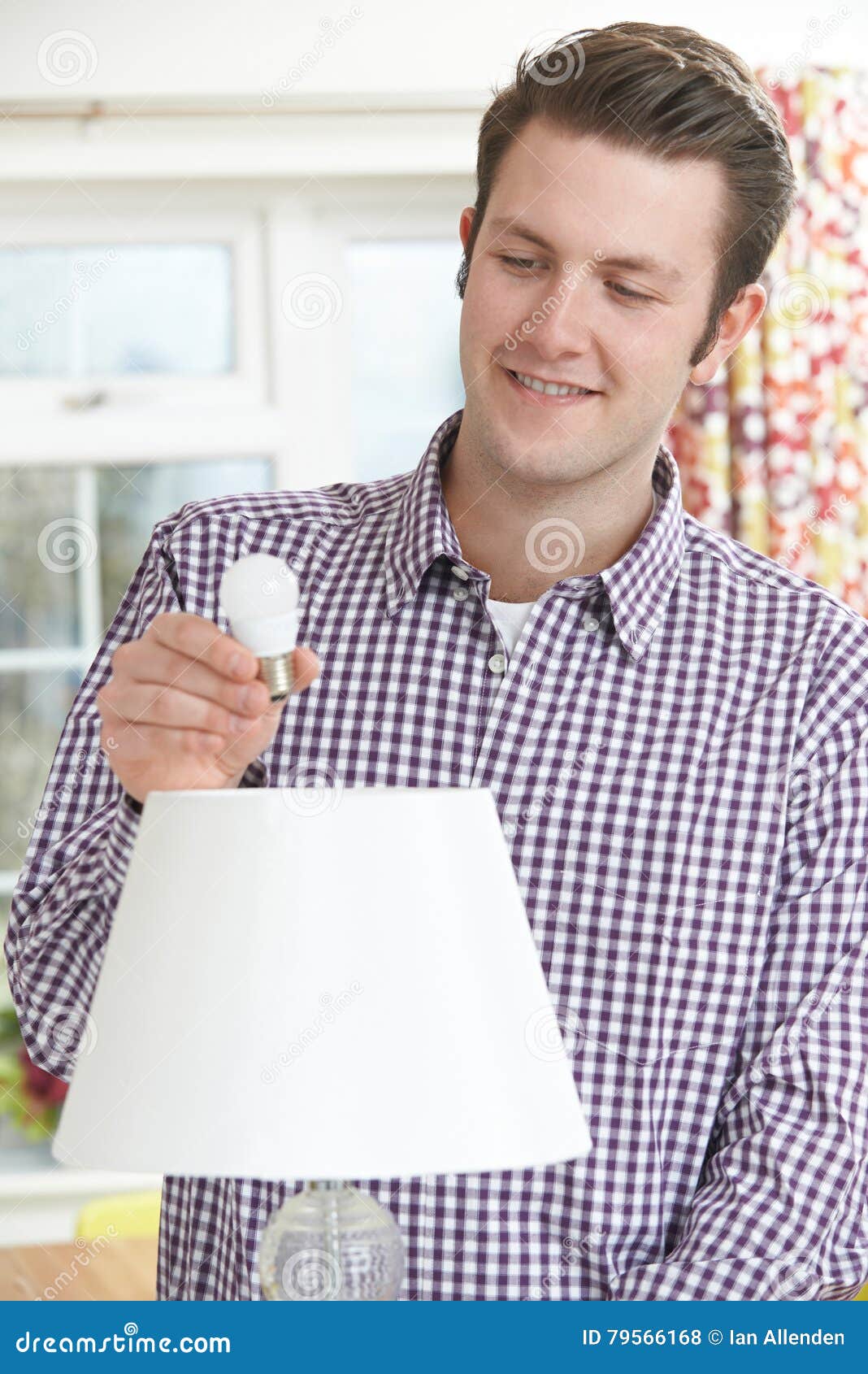 Man Putting Low Energy LED Lightbulb into Lamp at Home Stock Photo ...