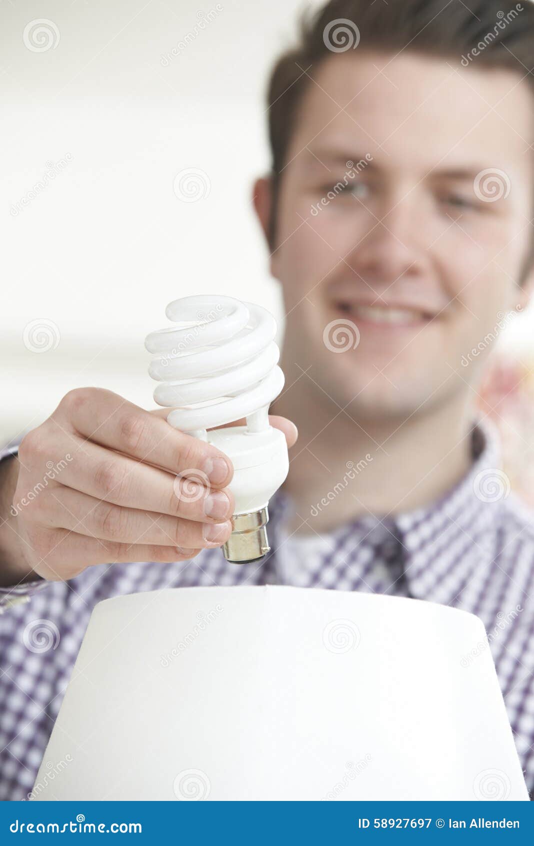 Man Putting Low Energy Lightbulb into Lamp at Home Stock Image - Image ...