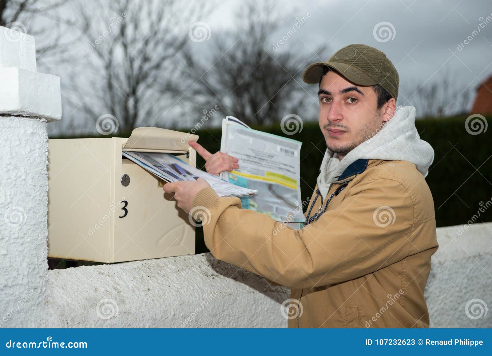 Man Putting Newspaper from the Mailbox Stock Image - Image of letterbox ...