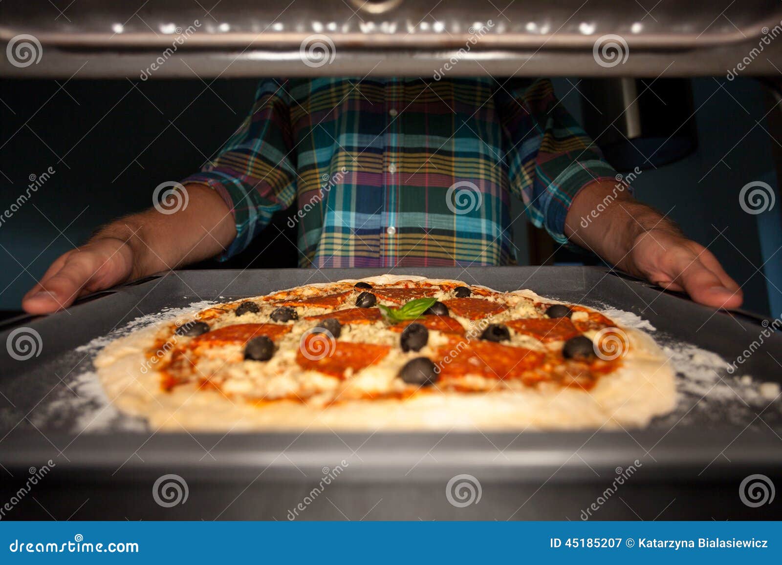 Man Putting Pizza into Oven Stock Image - Image of home, food: 45185207