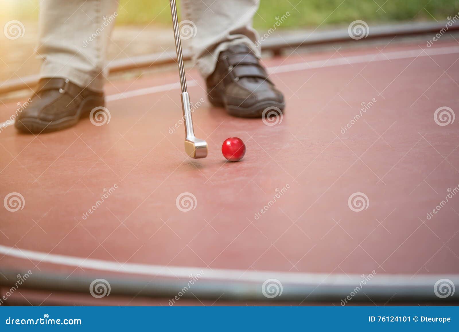 Man is Putting a Red Golf Ball with His Iron Racket Stock Image - Image ...
