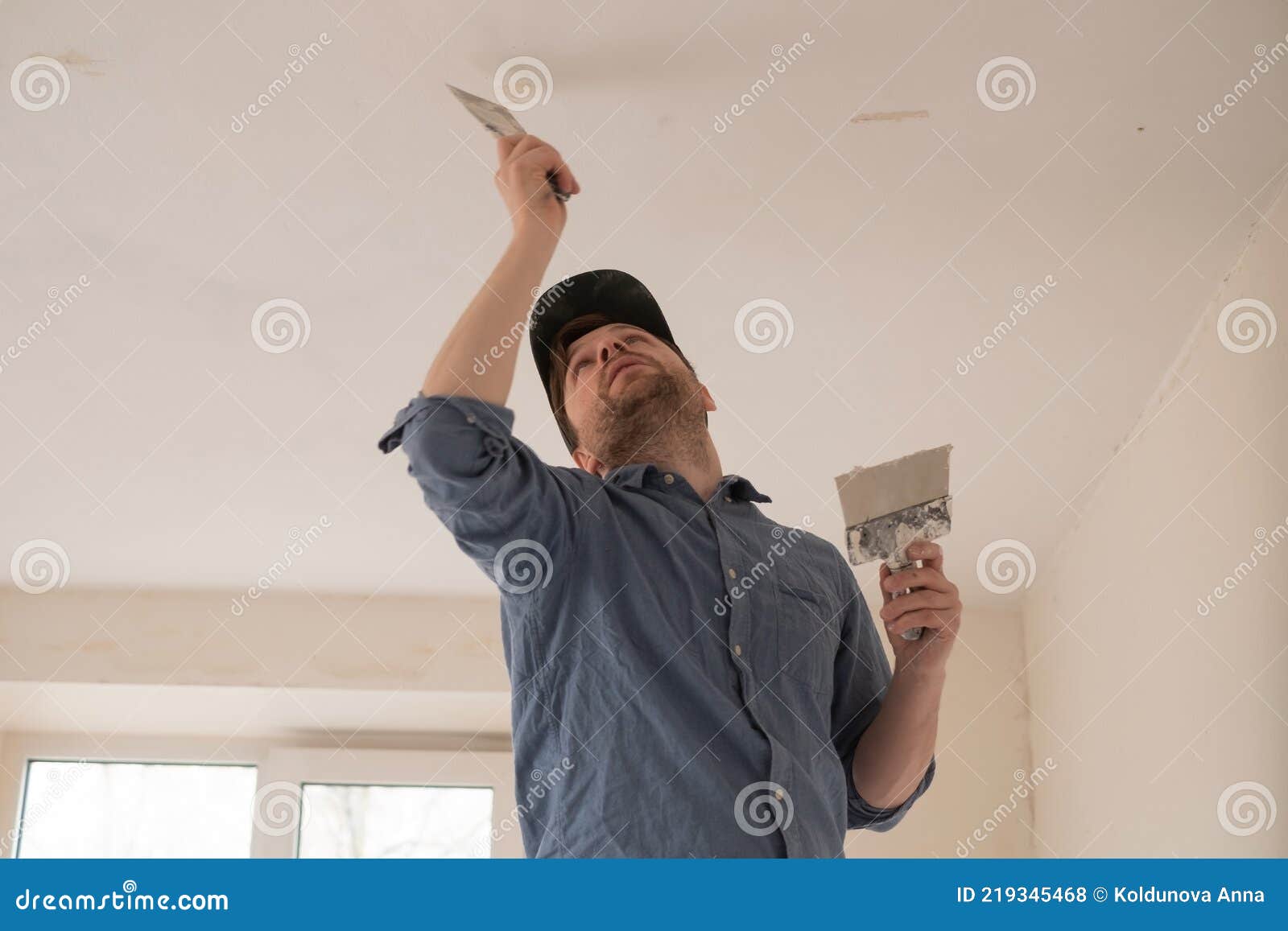 Man with Putty Knife Repairing Ceiling at Flat. Stock Photo - Image of ...