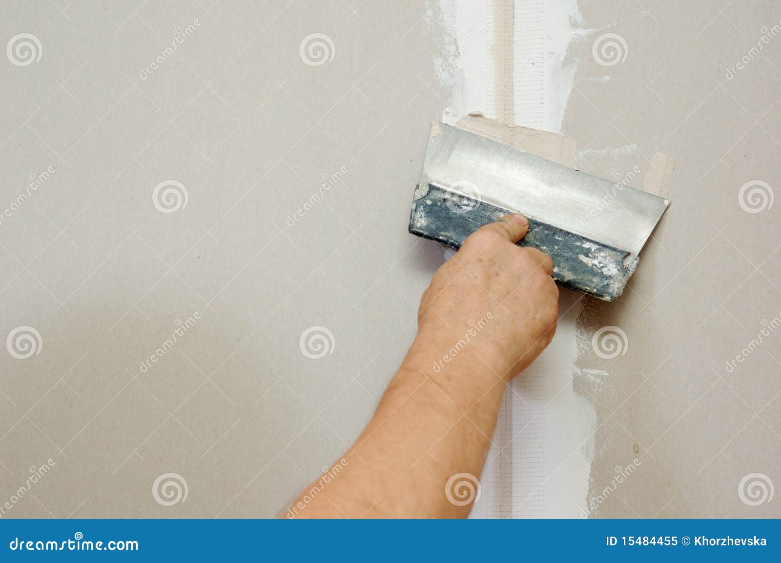 Man putty plasterboard stock image. Image of remodel - 15484455