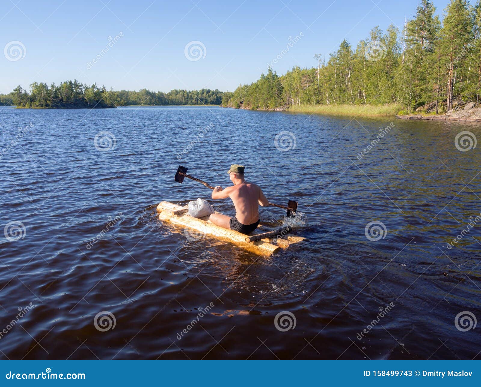 Man on a raft stock image. Image of raft, float, wood - 158499743