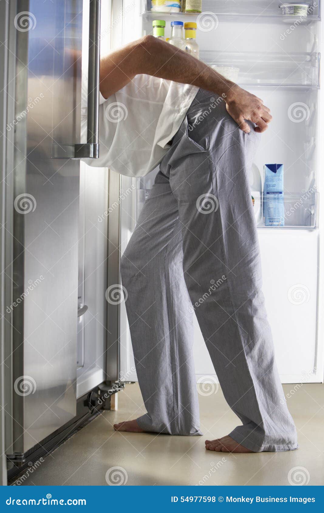 Man Raiding the Fridge at Night Stock Photo - Image of indoors, kitchen ...