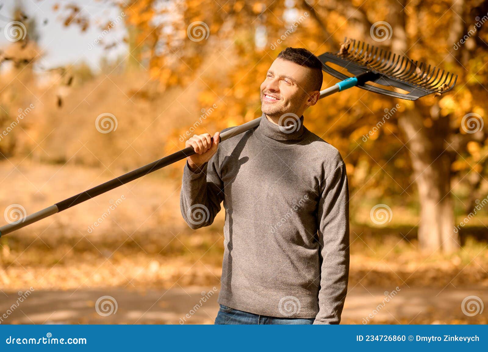 A Man with a Rake Standing in the Park Stock Photo - Image of yellow ...